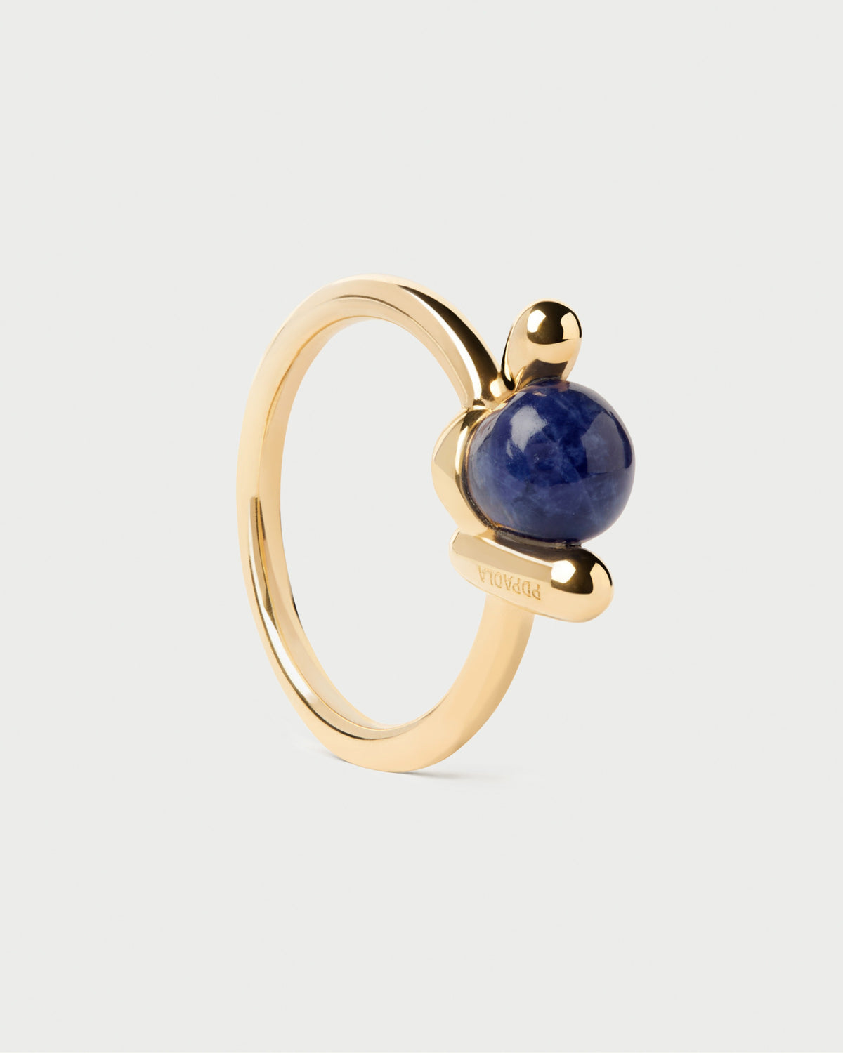 Fluid open knot ring inlaid with a round hand-carved royal blue gem ...