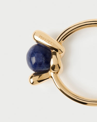 Fluid open knot ring inlaid with a round hand-carved royal blue gem ...