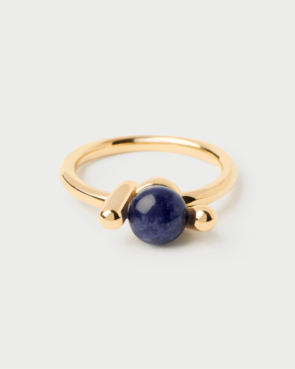 Fluid open knot ring inlaid with a round hand-carved royal blue gem ...