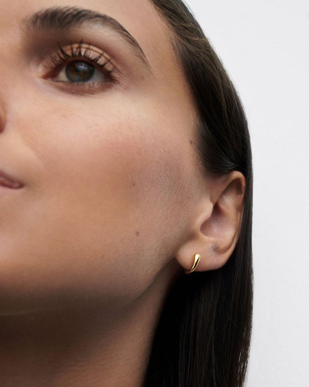 Mini single huggie hoop featuring sculptural drop-shaped motif and ...
