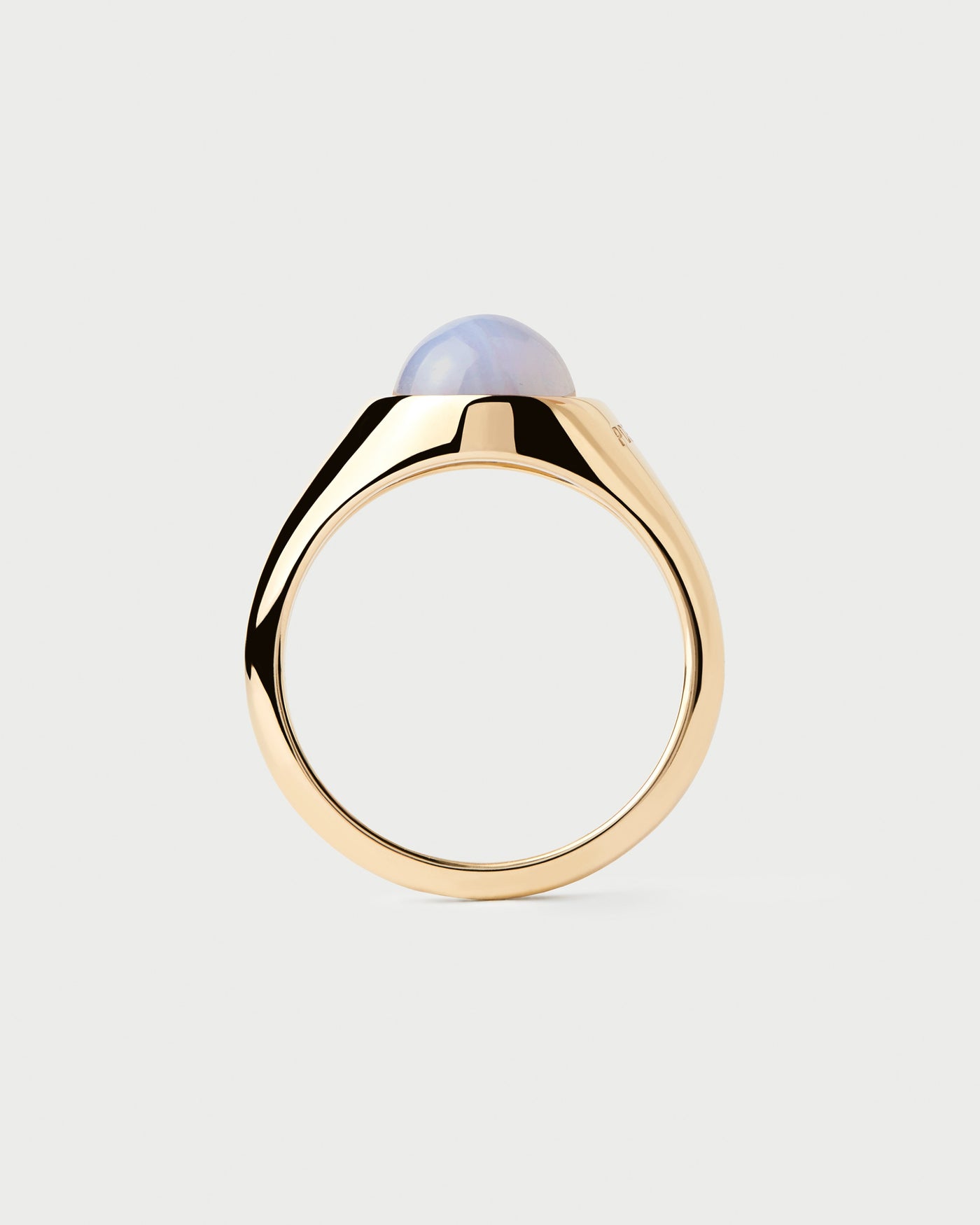Gold-plated half-sphere signet ring topped with an oval blue gemstone ...